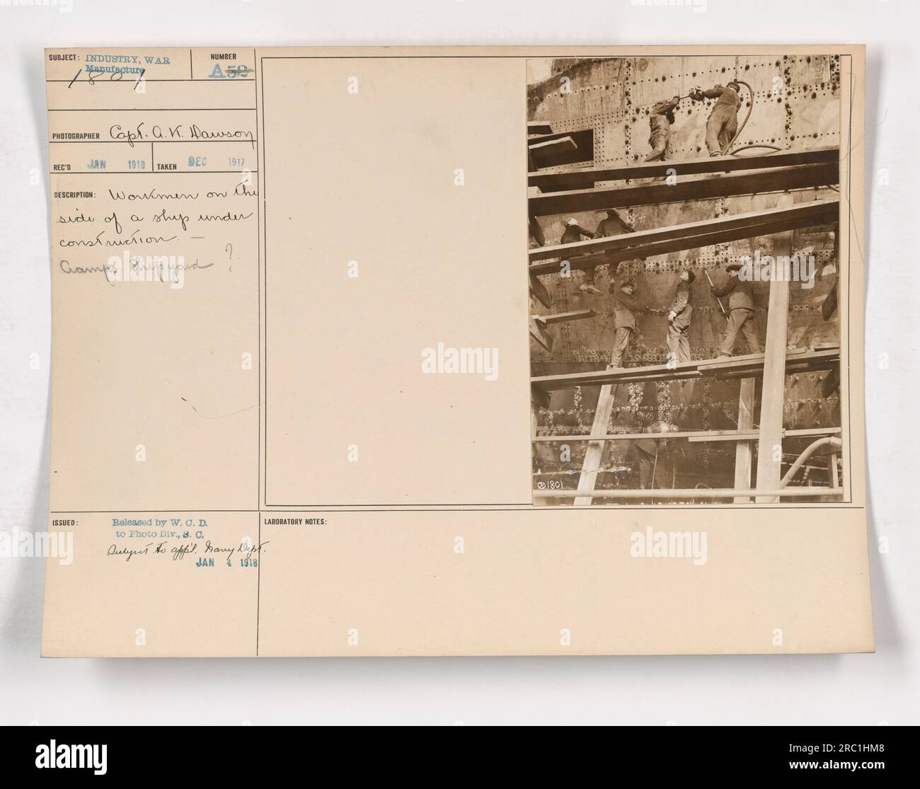 Workmen busy constructing a ship during World War One. Women can be ...