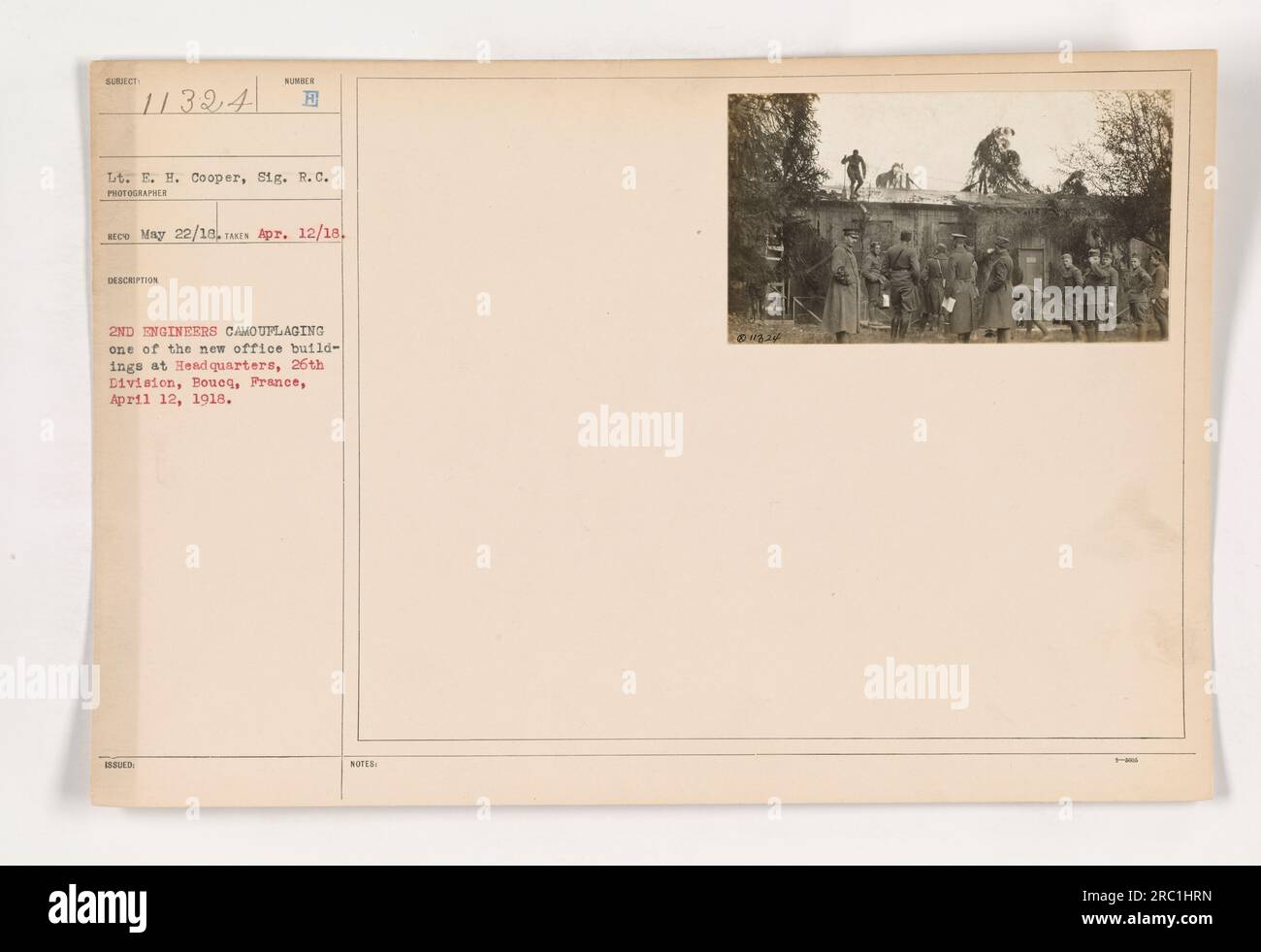 Soldiers camouflaging a new office building at the headquarters of the ...