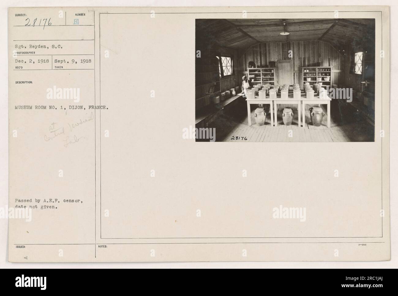 Group of American soldiers inspecting military equipment in a storage ...