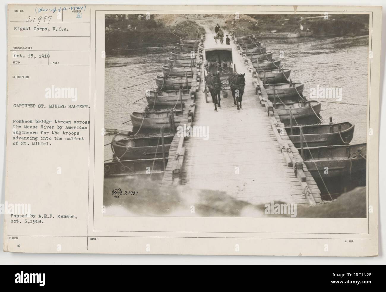 U.S. engineers construct a pontoon bridge across the Meuse River in the ...