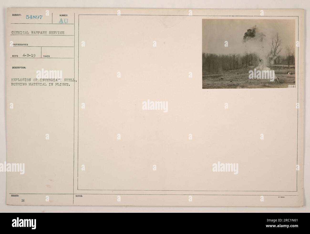 In this photograph, an incendiary shell ignites in mid-air, releasing ...