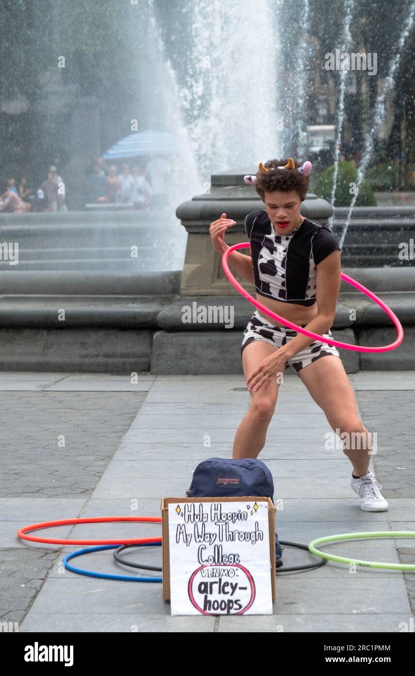 A superstar hula hooping student performs with multiple hoops in a park ...