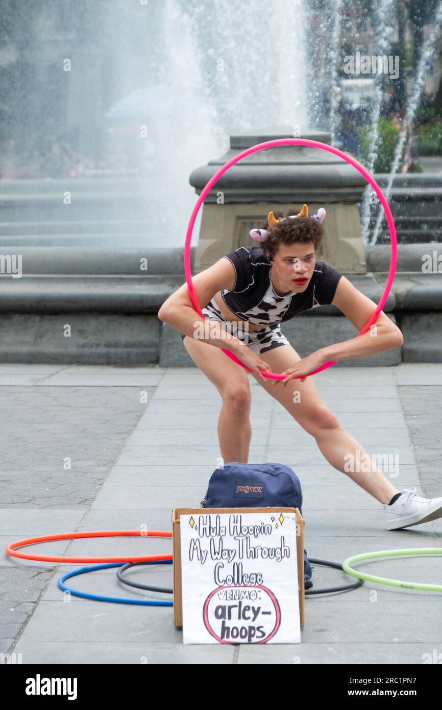 A superstar hula hooping student performs with multiple hoops in a park ...