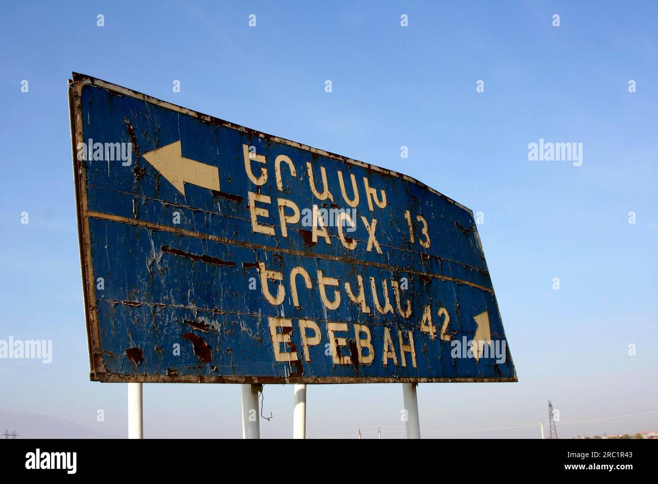 Rusty road sign in Armenian and Cyrillic 42km in front of Yerevan ...