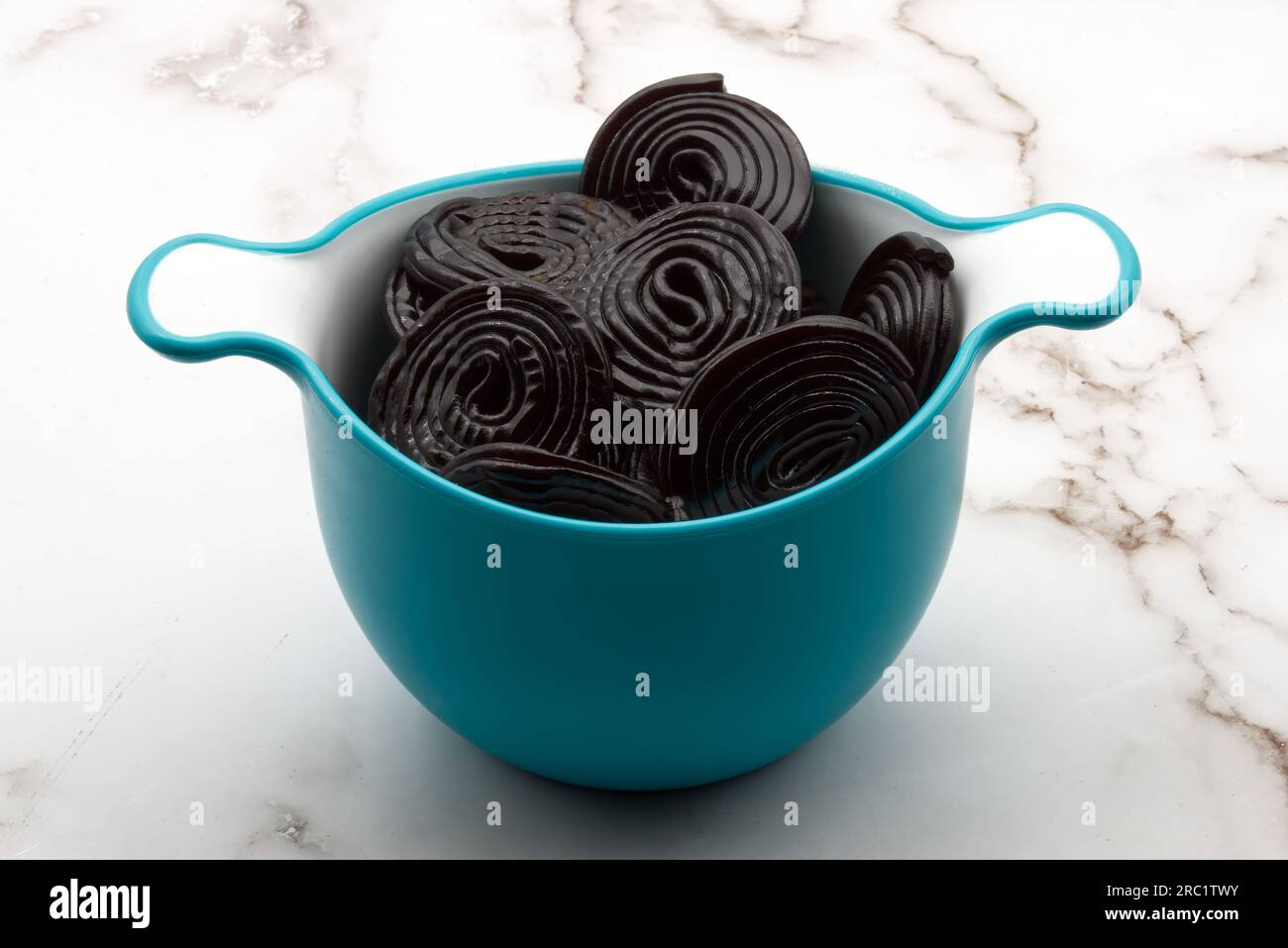 Tasty black licorice candies on white marble background Stock Photo - Alamy