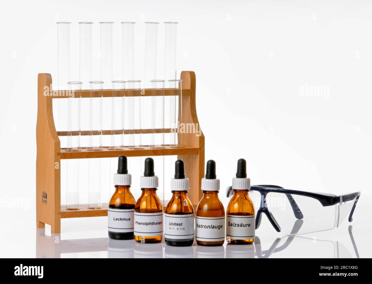 Rack with test tubes, glasses, pipette vials with chemicals, litmus ...