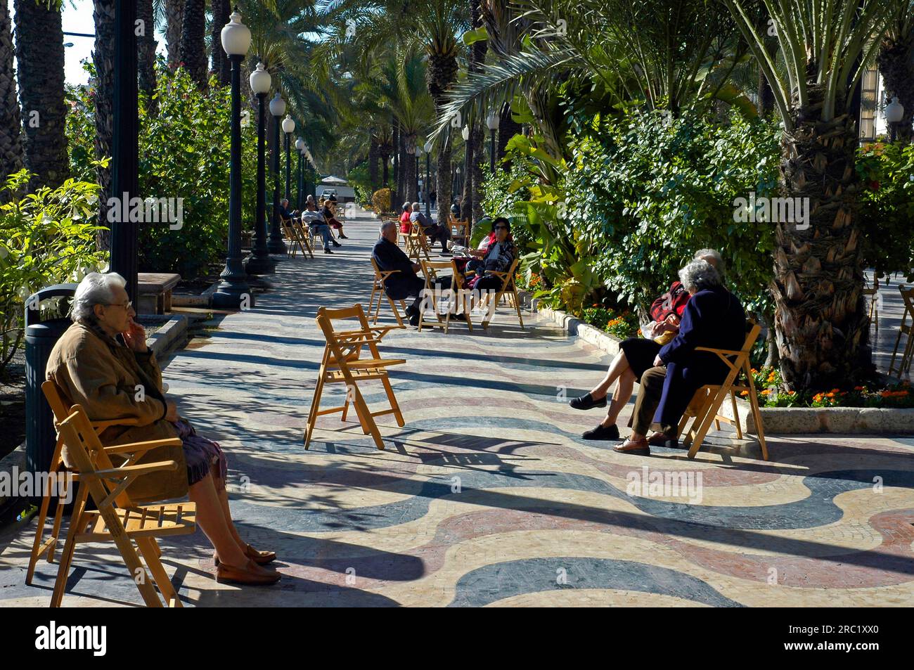 People on chairs at promenade Explanada de Espana, Alicante, Costa ...