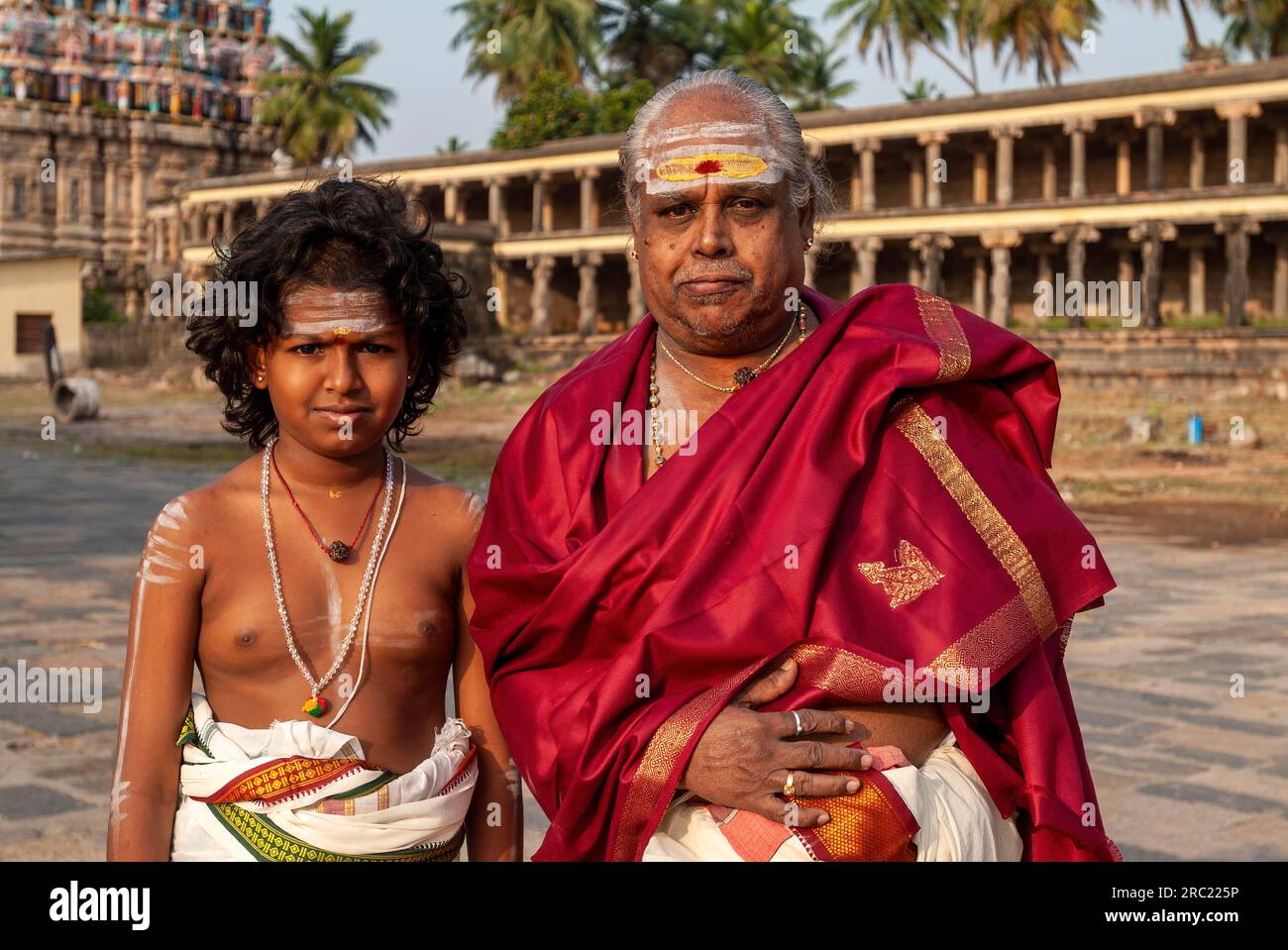 Priest standing with his son in Thillai Nataraja temple in Chidambaram ...