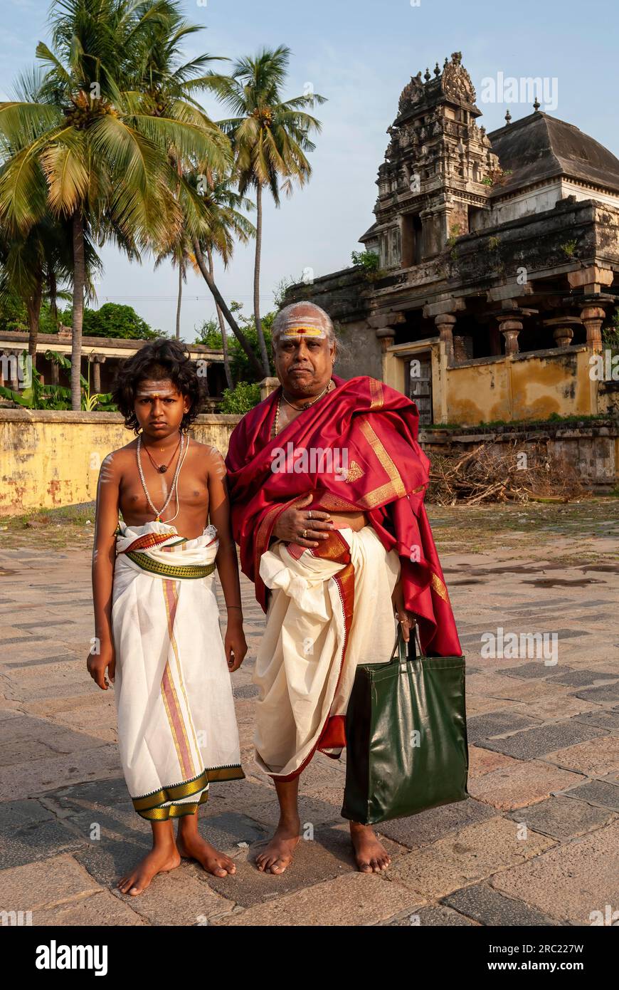 Priest standing with his son in Thillai Nataraja temple in Chidambaram ...