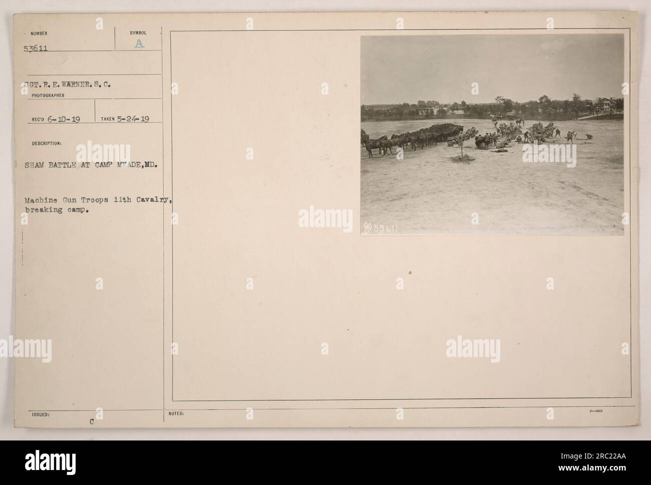 A photograph of machine gun troops from the 11th Cavalry breaking camp ...