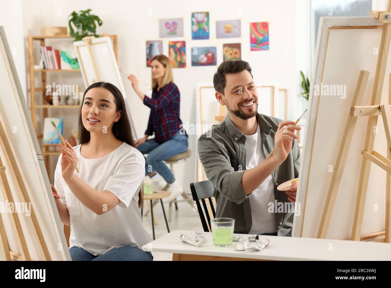Group of students attending painting class in studio. Creative hobby ...