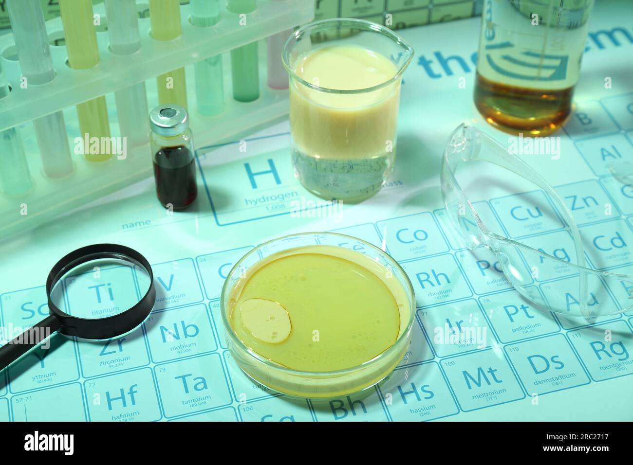 Different laboratory equipment with liquids and safety glasses on ...