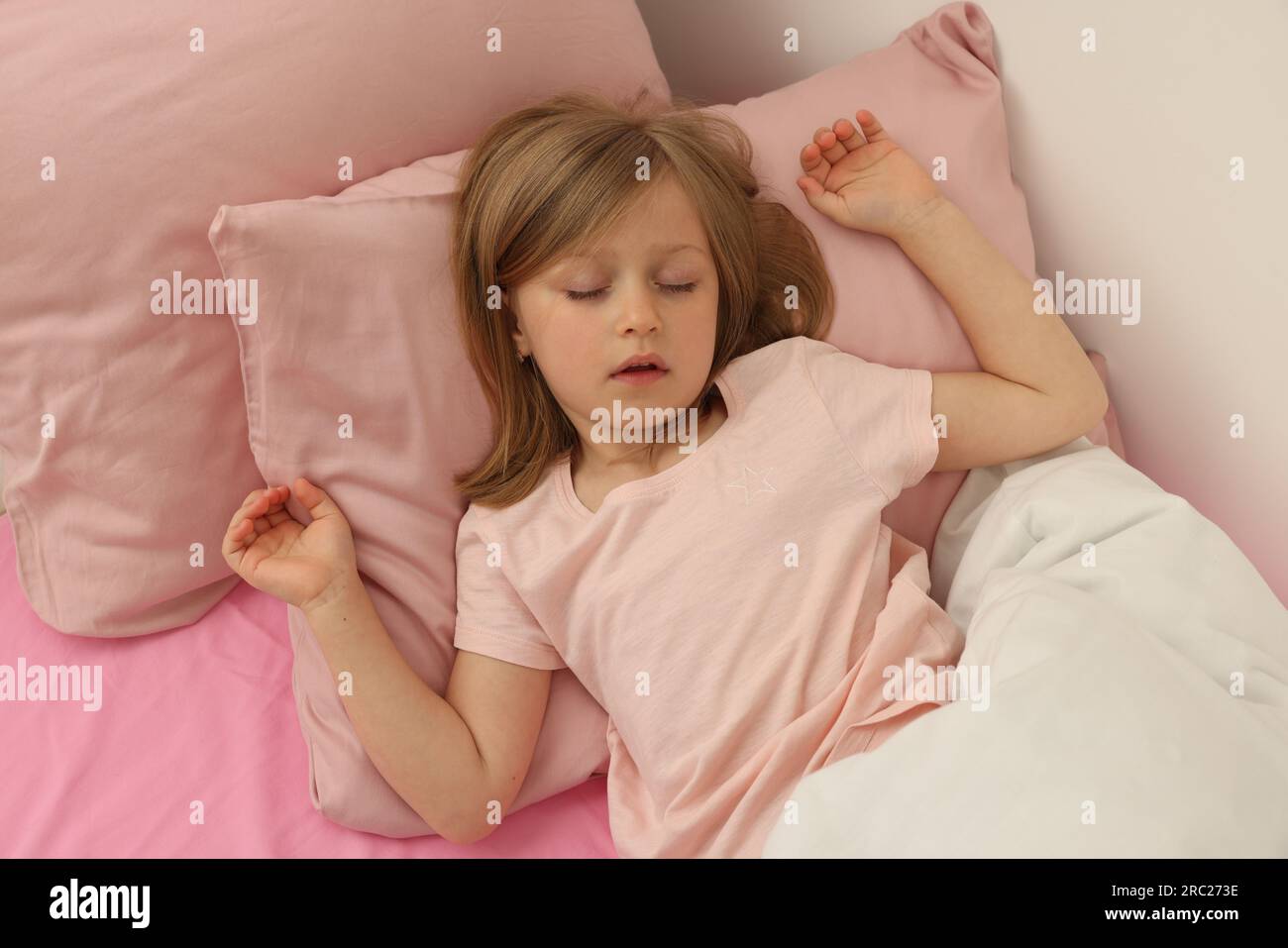 Little girl snoring while sleeping in bed Stock Photo - Alamy