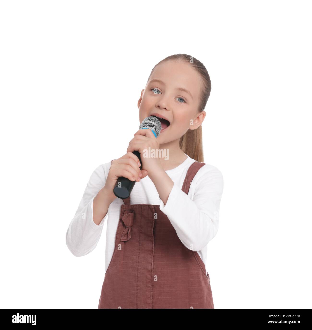 Cute little girl with microphone singing on white background Stock ...