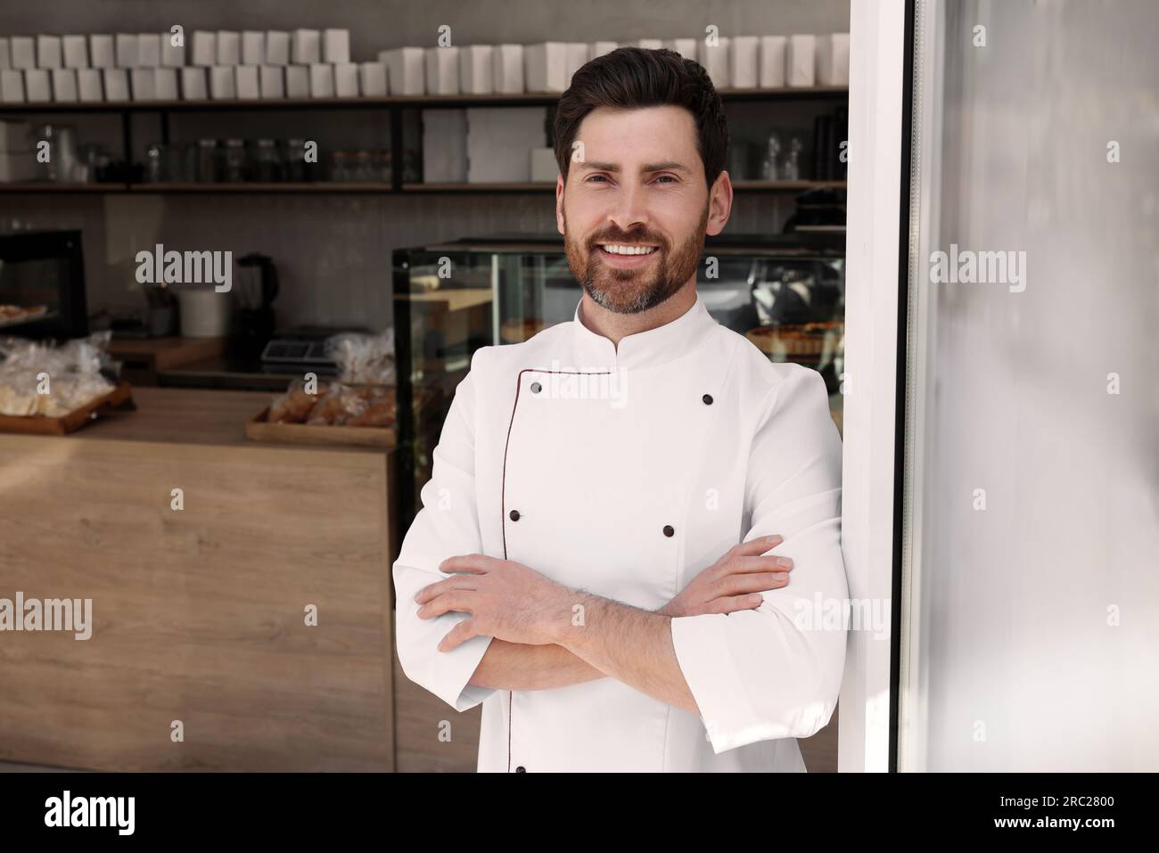 Portrait of professional baker in bakery shop. Space for text Stock ...