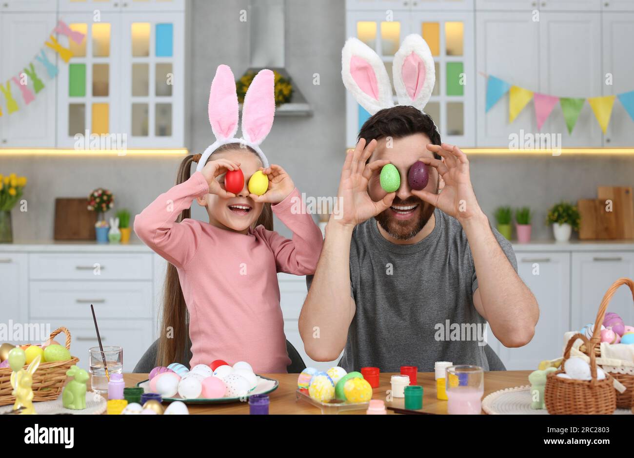 Father and his cute daughter covering eyes with beautifully painted ...