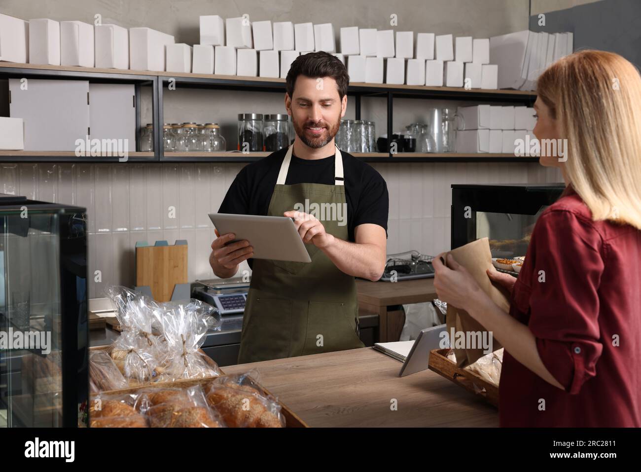 Woman buying fresh pastries in bakery shop Stock Photo - Alamy