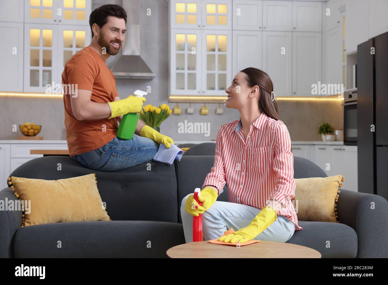 Spring cleaning. Lovely couple tidying up living room together Stock ...