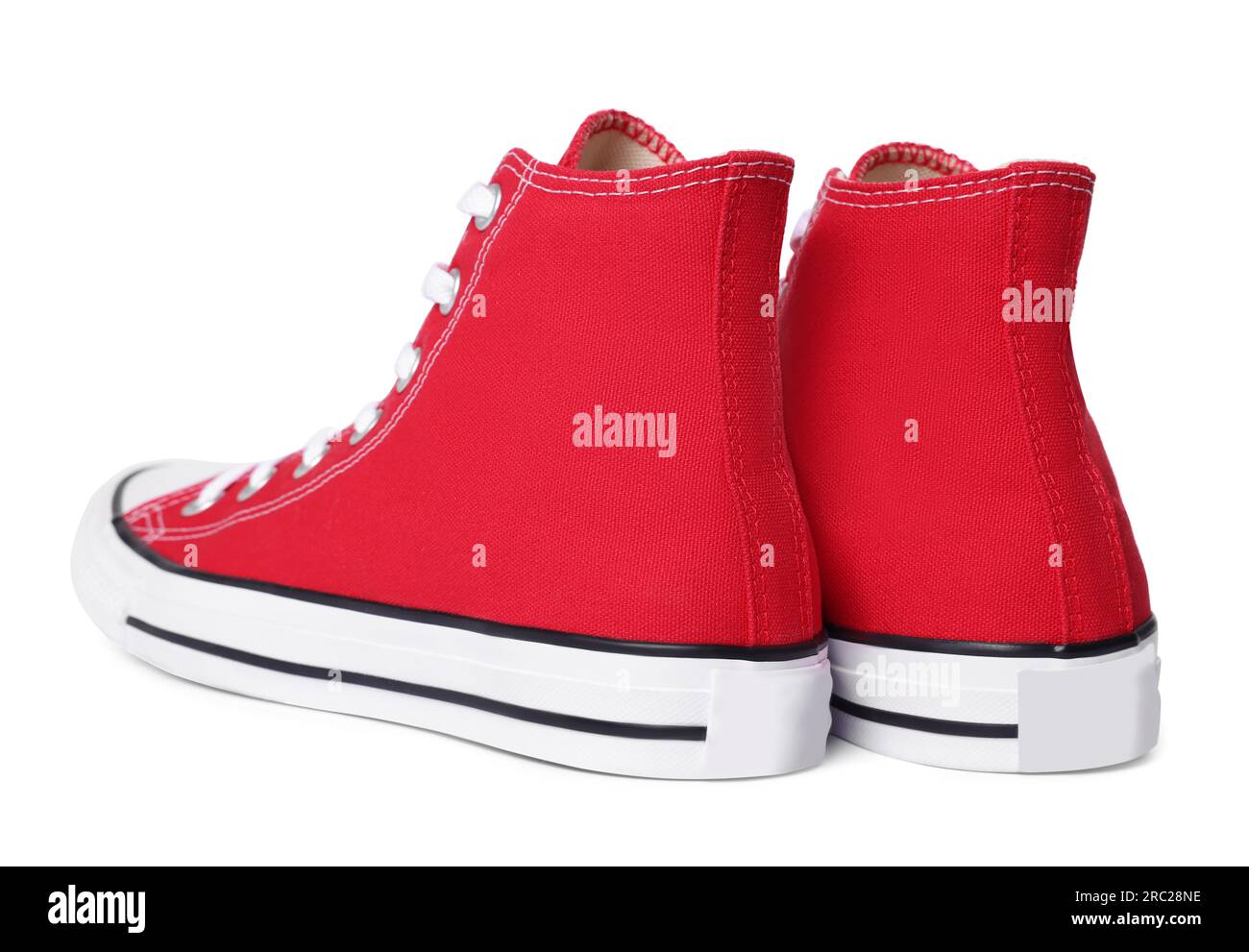 Pair of new red stylish high top plimsolls on white background Stock ...
