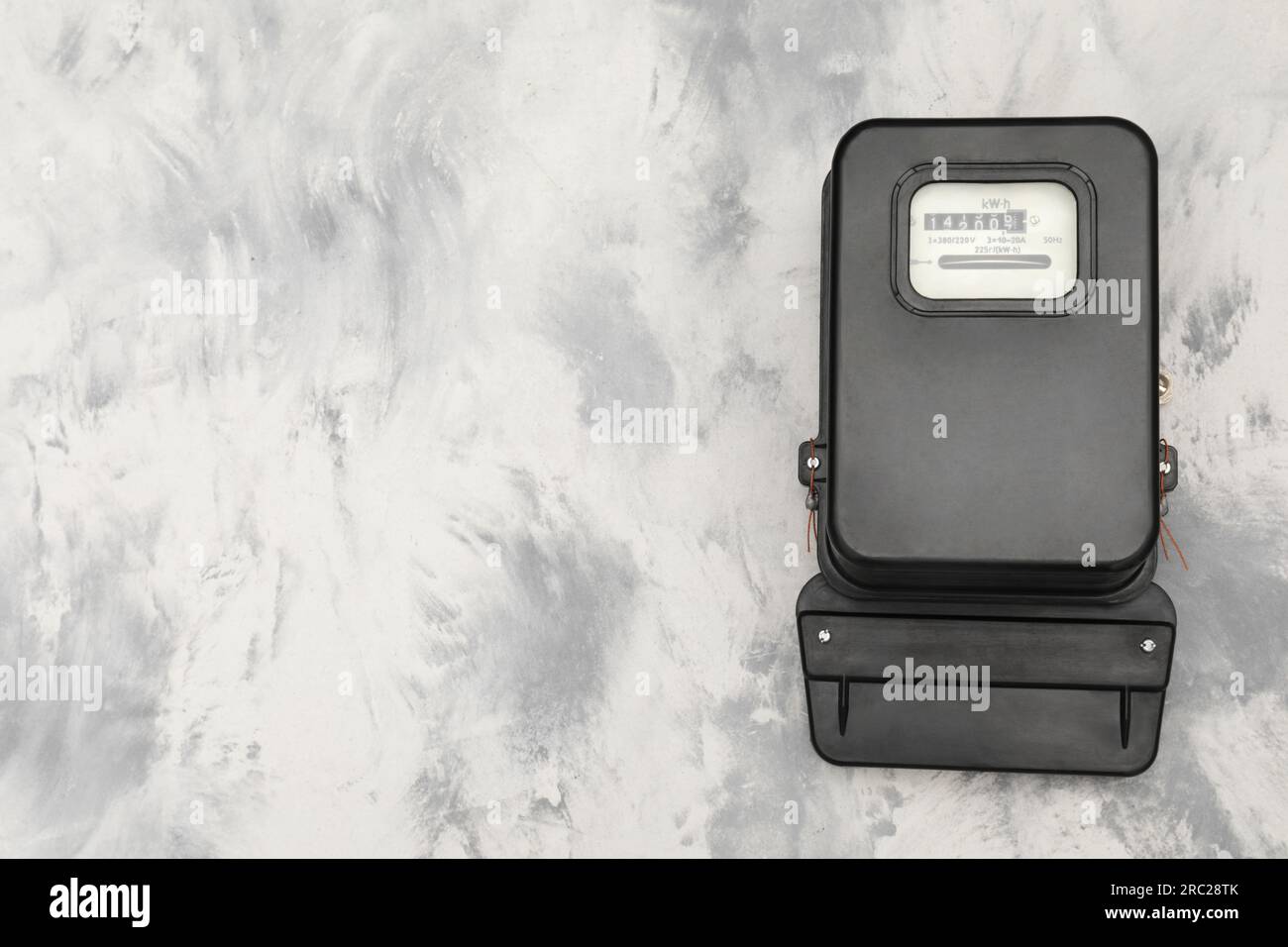 Black electric meter on textured background, top view with space for ...