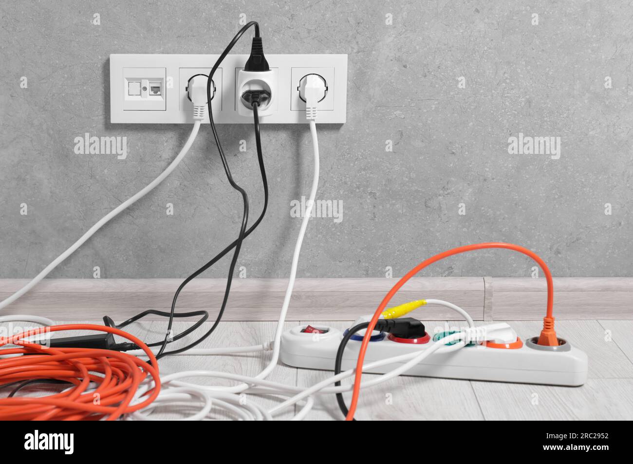 Extension cord with power plugs in sockets indoors, space for text ...