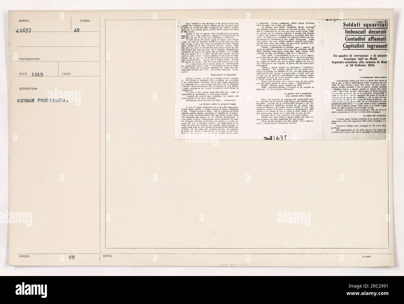 A group of American soldiers examining German propaganda materials ...