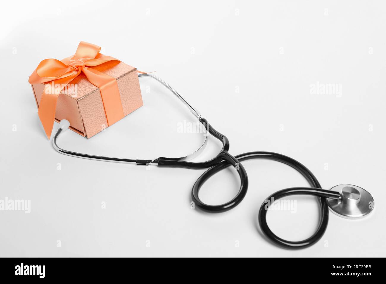 Stethoscope and gift box on white background. Happy Doctor's Day Stock ...