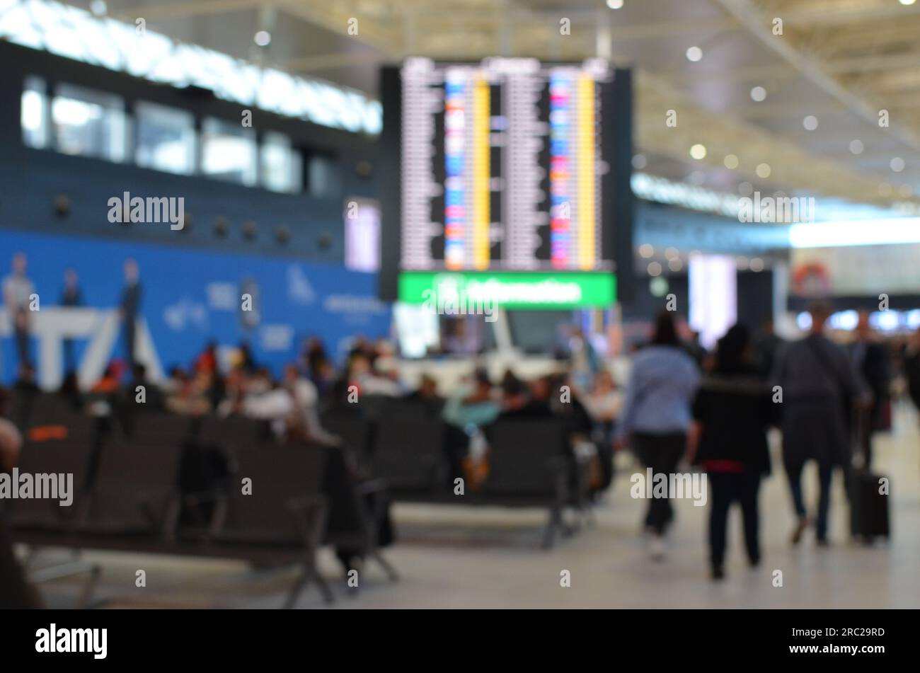 Blurred view of crowded airport waiting area Stock Photo - Alamy