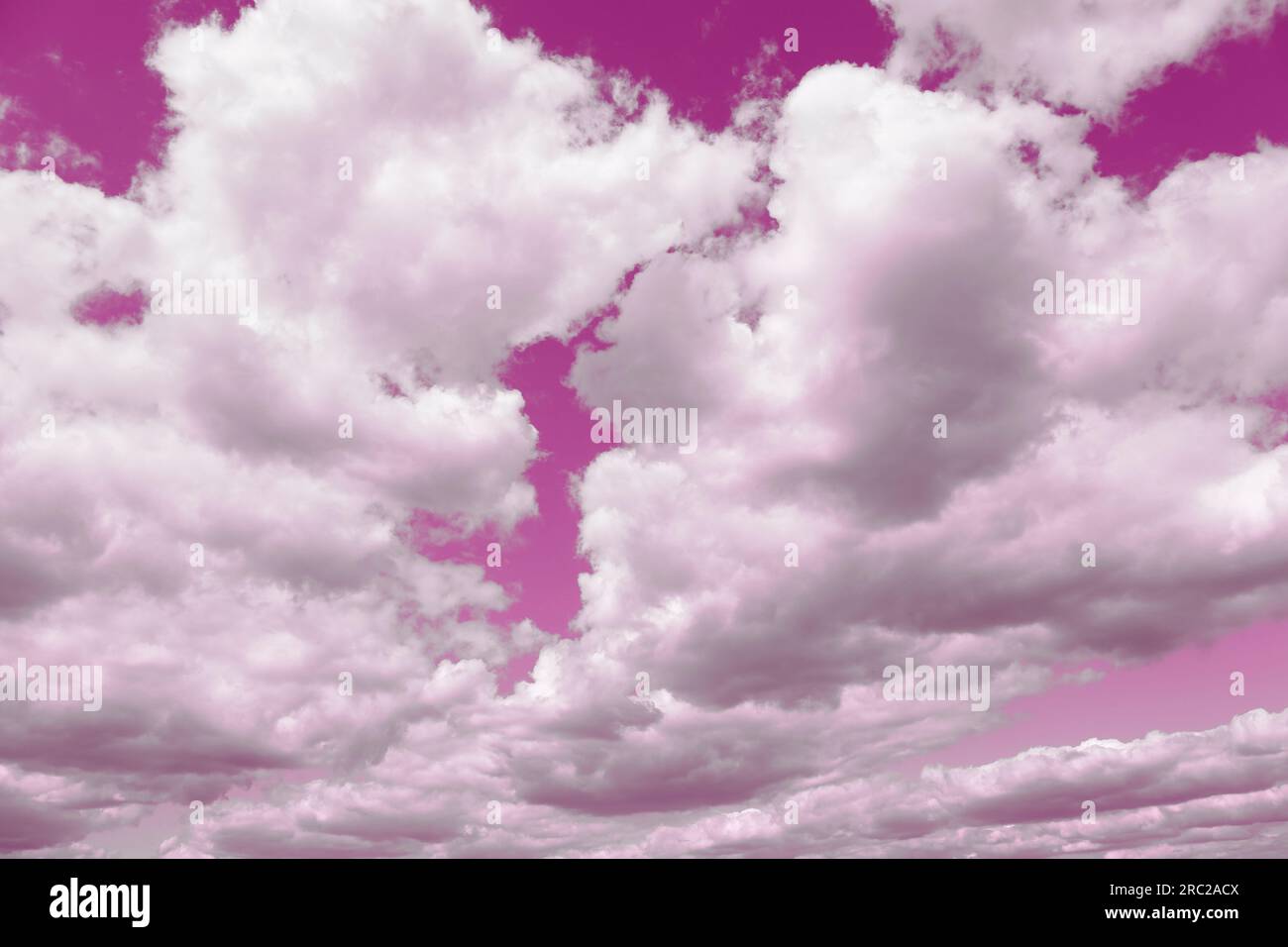Fluffy clouds floating in beautiful pink sky Stock Photo - Alamy