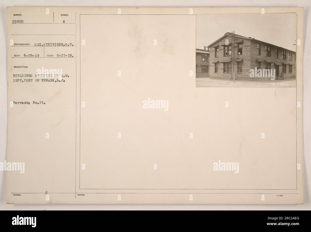 A photograph depicting Barracks No. 21, the buildings occupied by the Q ...