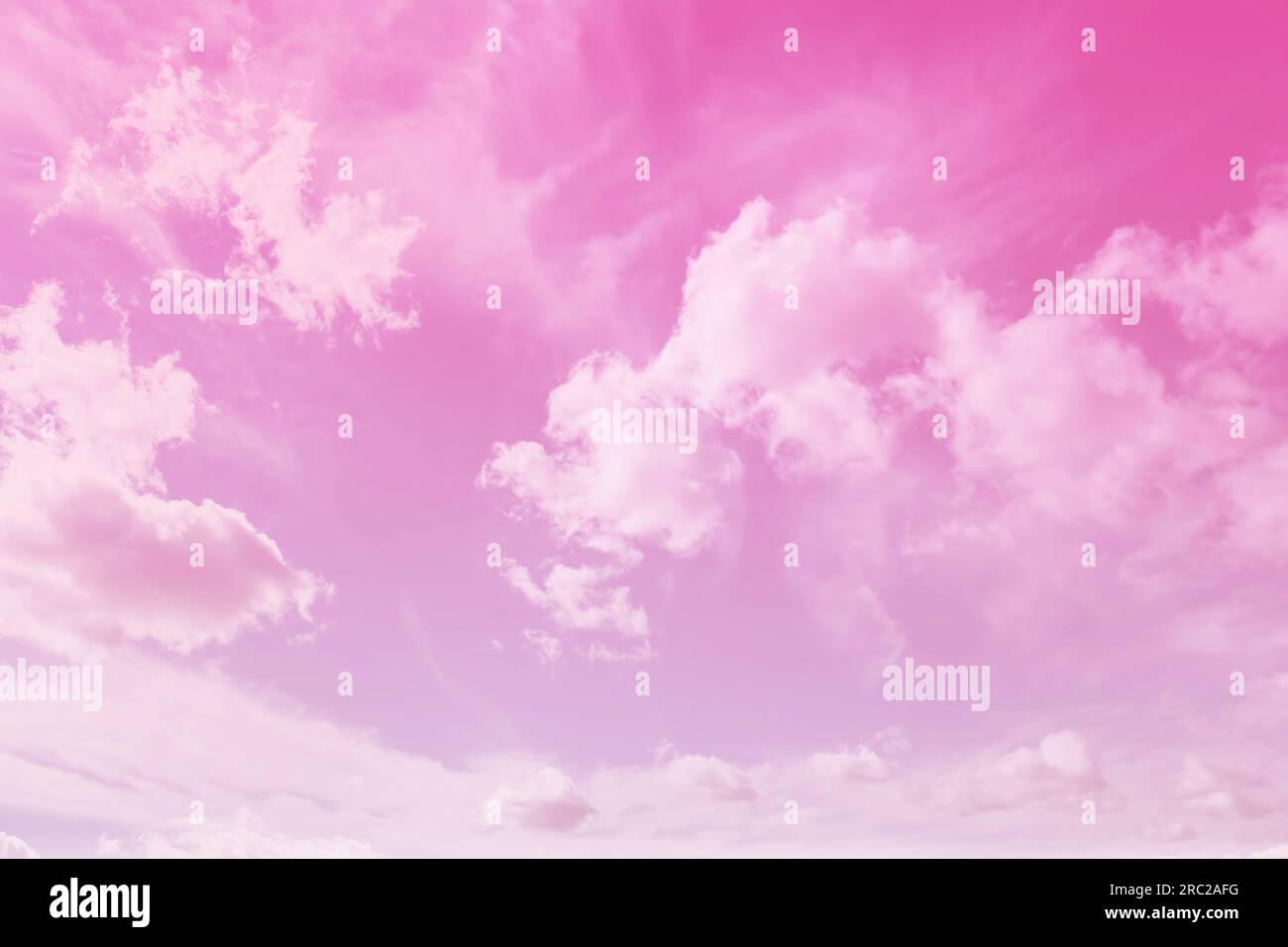 Fluffy clouds floating in beautiful pink sky Stock Photo - Alamy