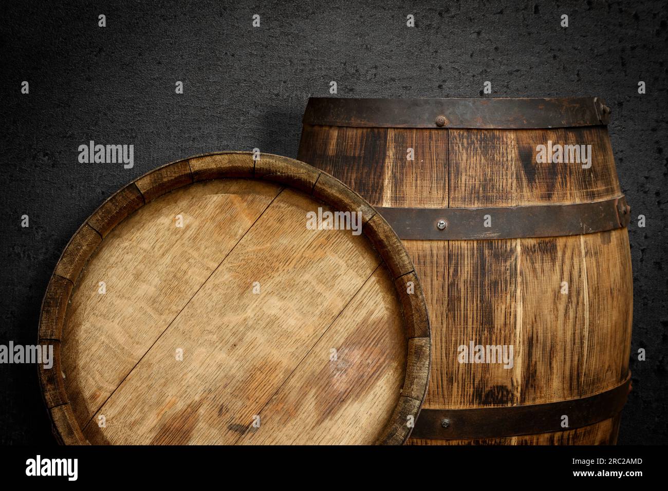 Two wooden barrels near dark textured wall Stock Photo - Alamy