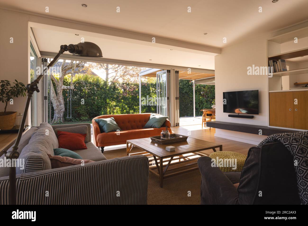 Interior of a living room with television, couch and armchair over big ...