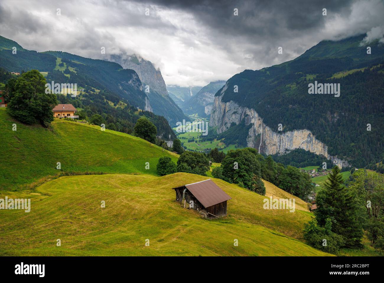view from Wengen with farm shed through clouds into Lauterbrunnen ...