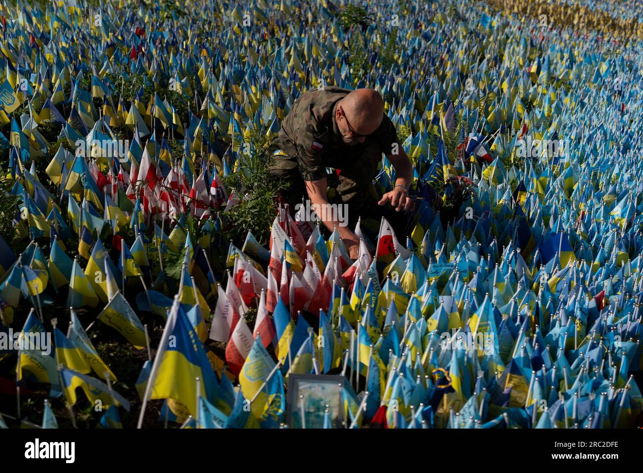 Polish Army veteran Slawomir Wysocki, 50, places the country's flag at ...
