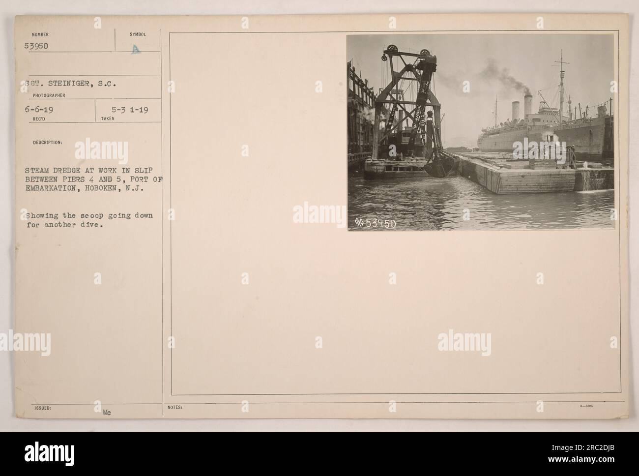 A steam dredge is seen in action in the slip between Piers 4 and 5 at ...