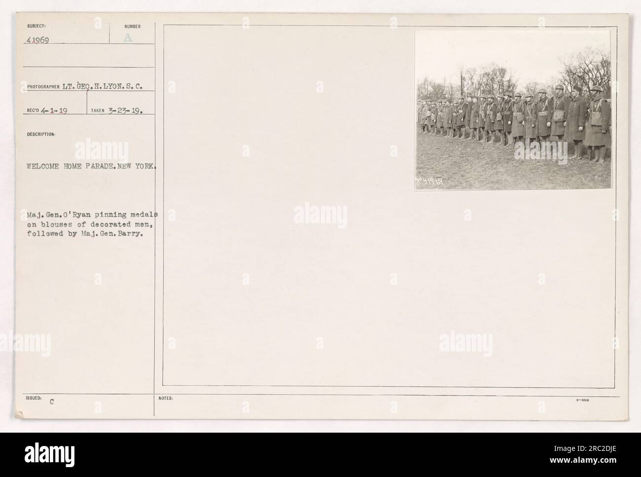 Maj. Gen. O'Ryan pinning medals on decorated soldiers' blouses followed ...