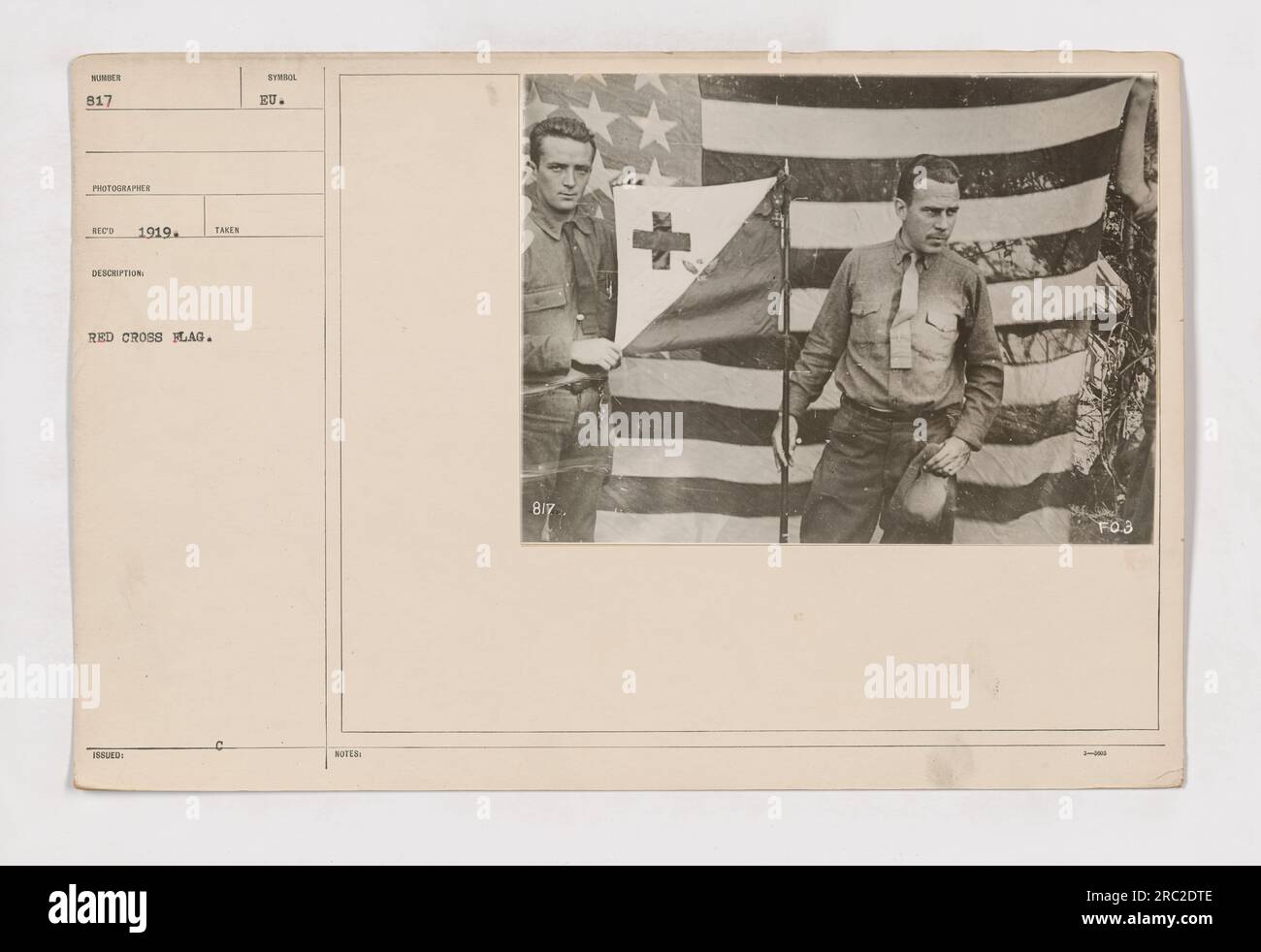 The photograph depicts a Red Cross flag flying high during World War I ...