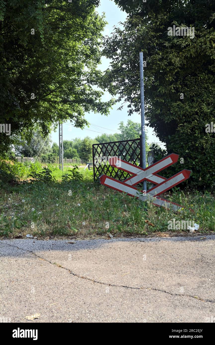 Abandoned railroad crossing in a grove on a sunny day in the italian ...