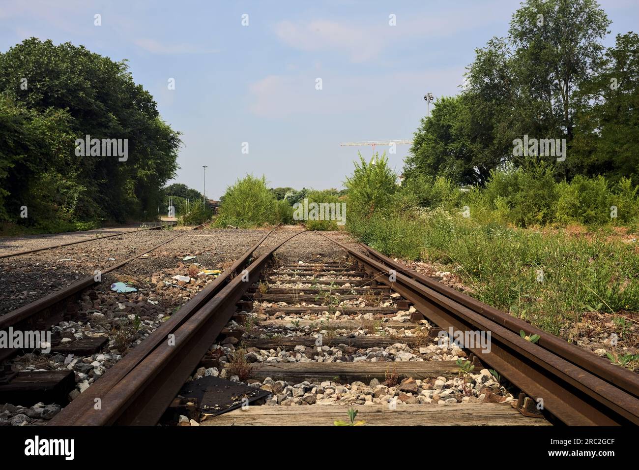 Abandoned railroad tracks next to a building in an italian town in ...