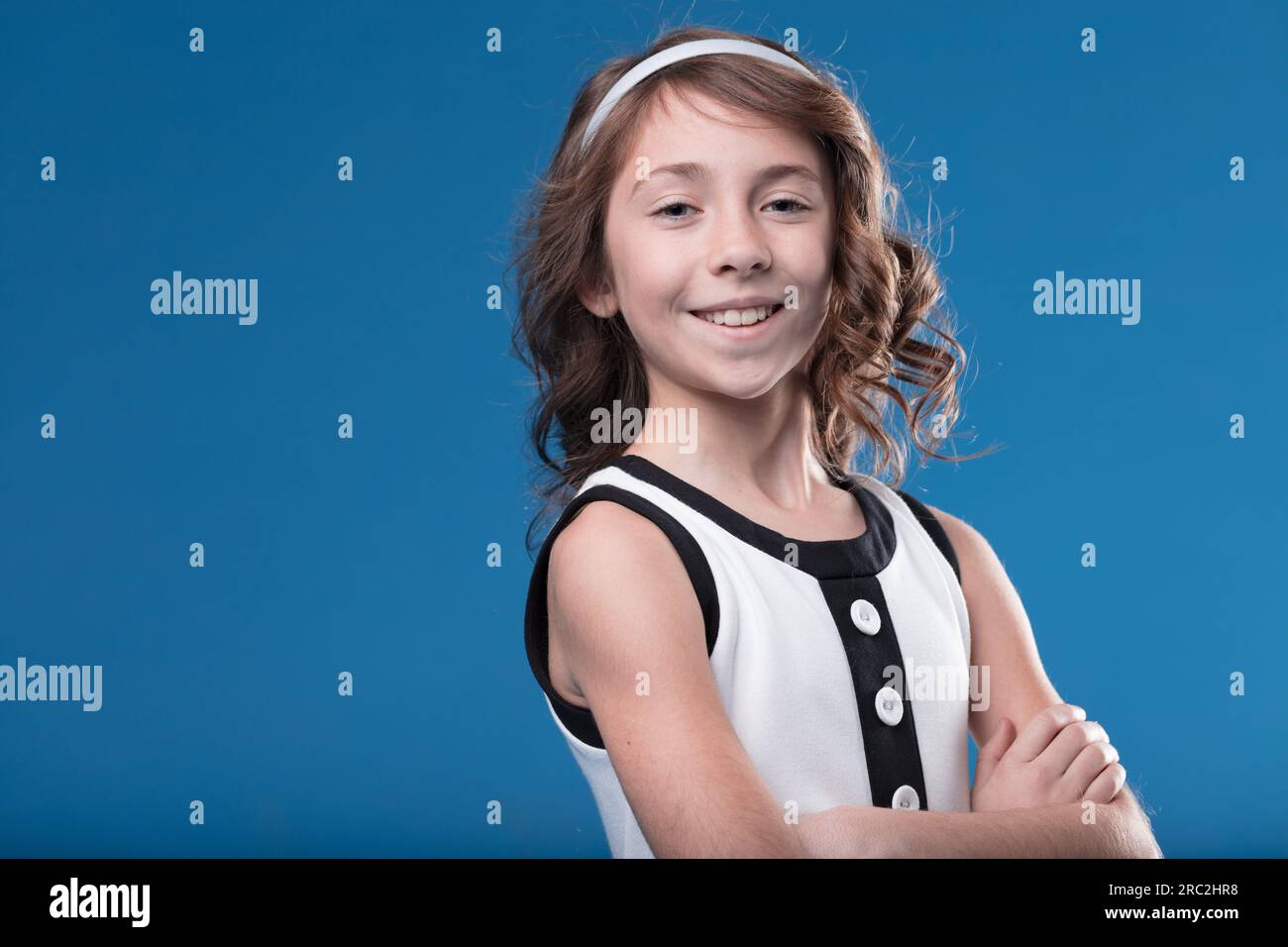 Formal portrait of a smiling girl in black and white outfit against ...