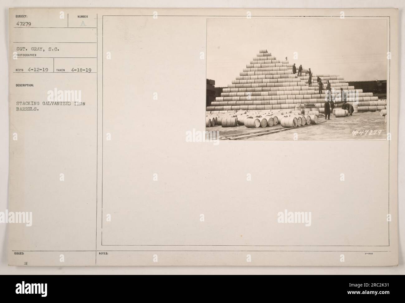 Soldiers stacking galvanized iron barrels at the Sumber base during ...