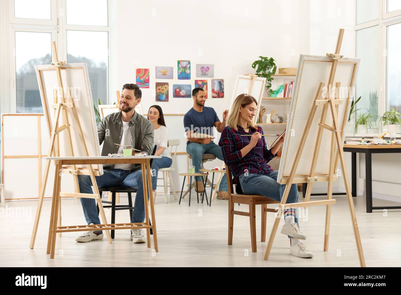 Group of students attending painting class in studio. Creative hobby ...