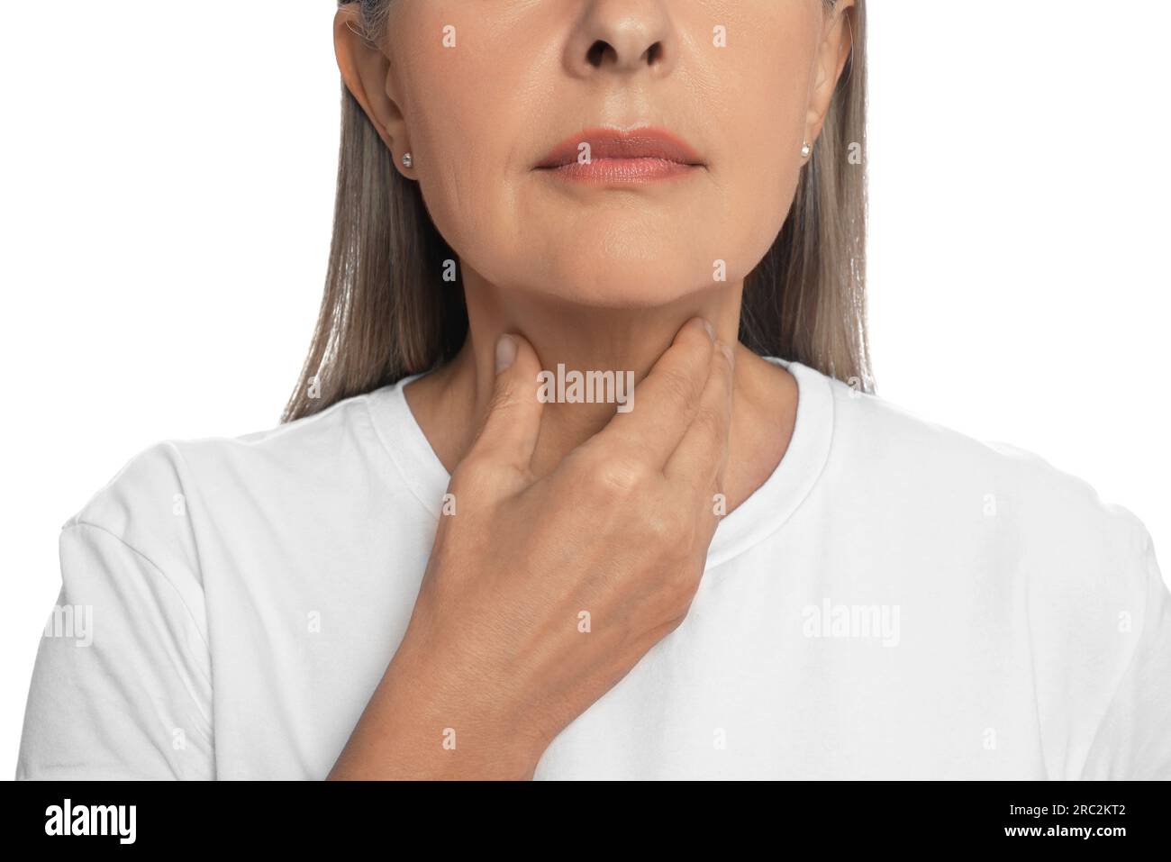 Endocrine system. Senior woman doing thyroid self examination on white ...