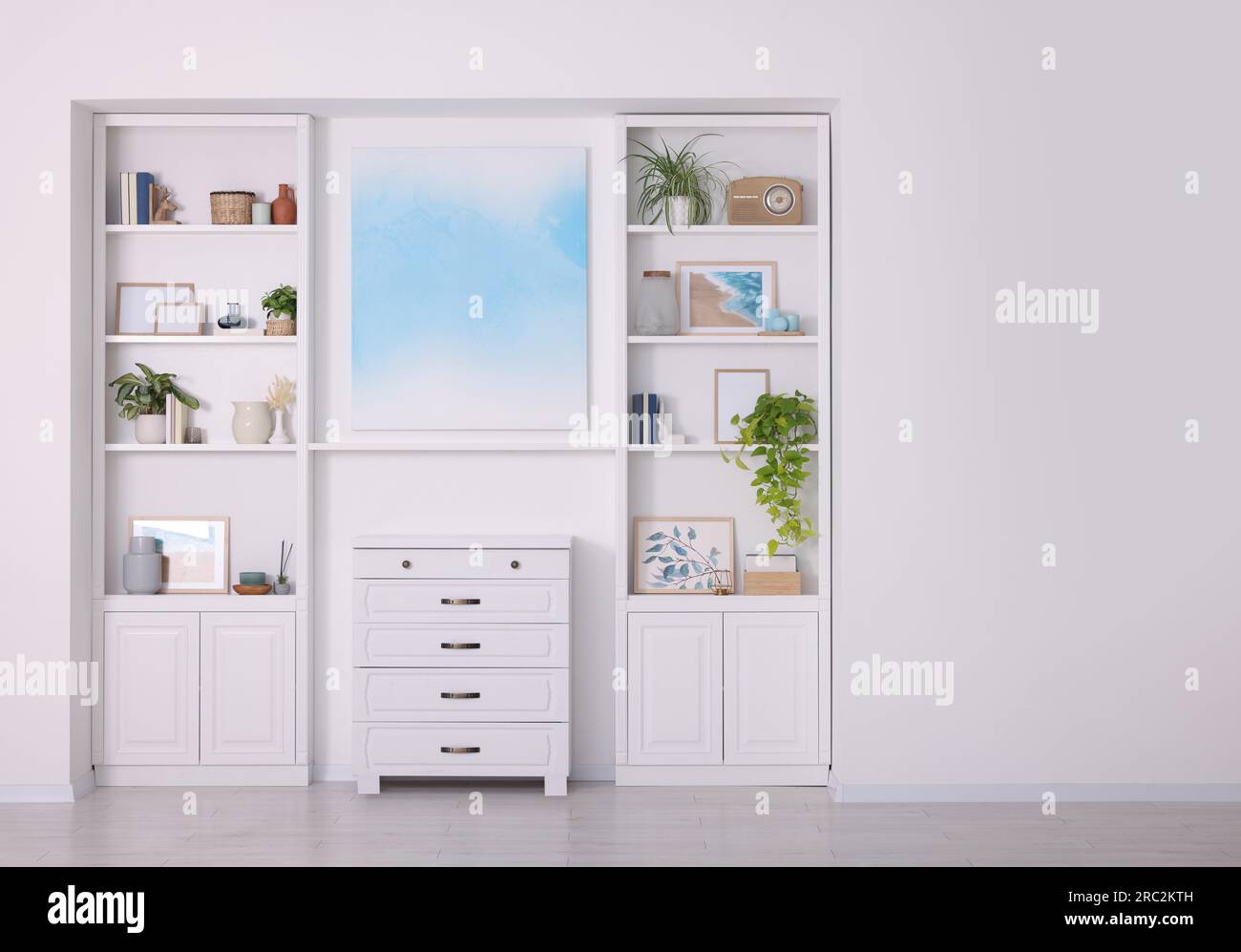 Interior design. Abstract picture and chest of drawers between shelves ...