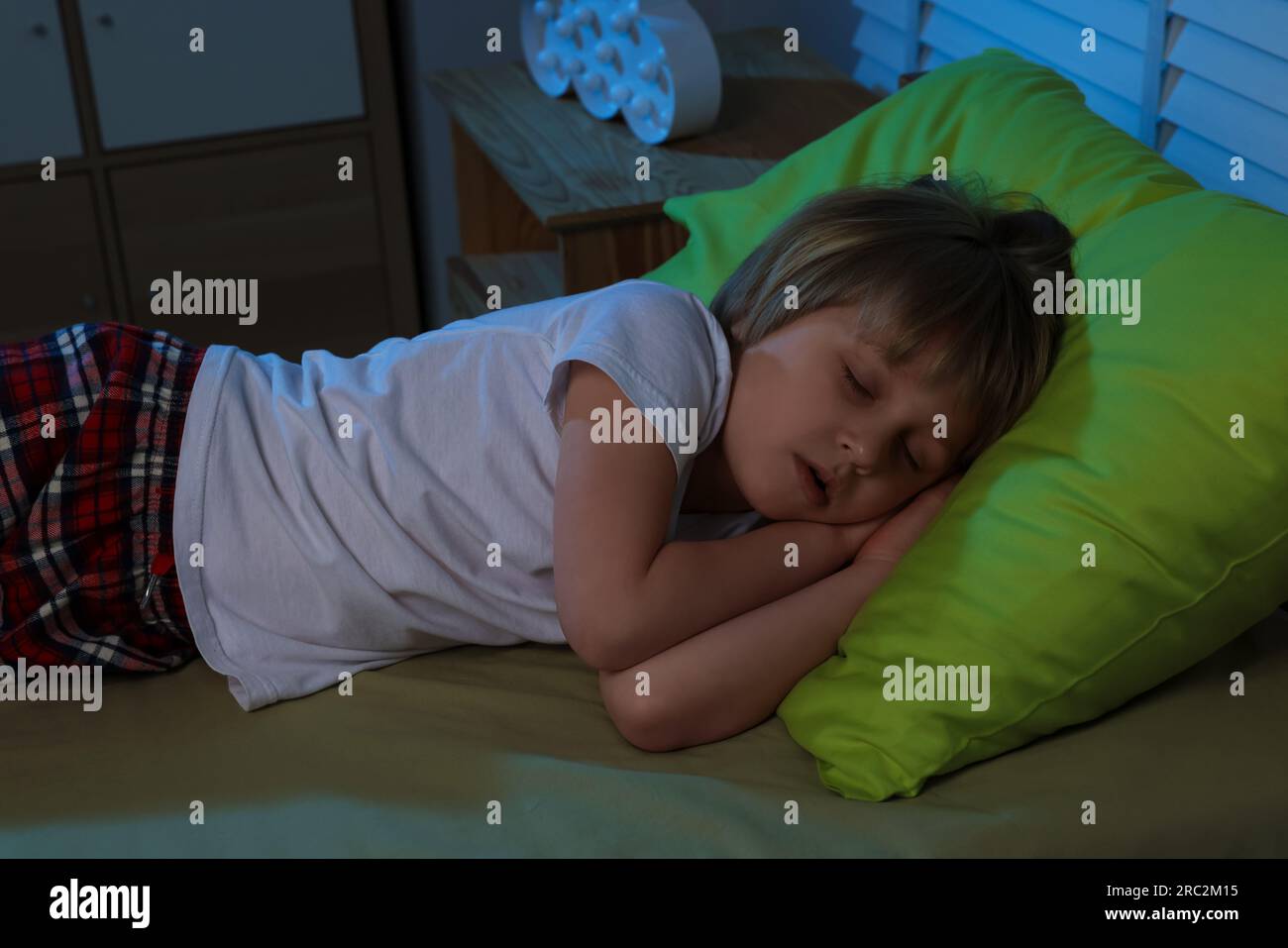 Little boy snoring while sleeping on bed at night Stock Photo - Alamy