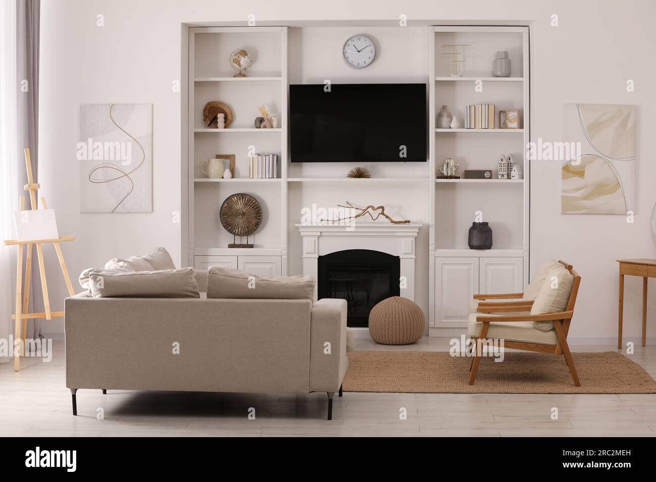 Cozy room interior with stylish furniture, decorative fireplace and TV ...