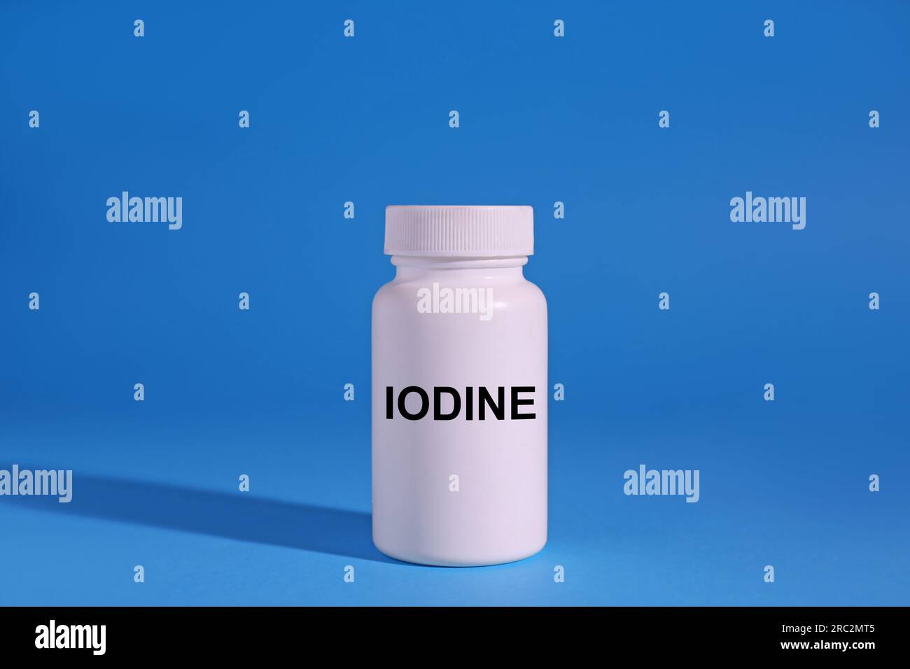 Plastic container of medical iodine on light blue background Stock ...