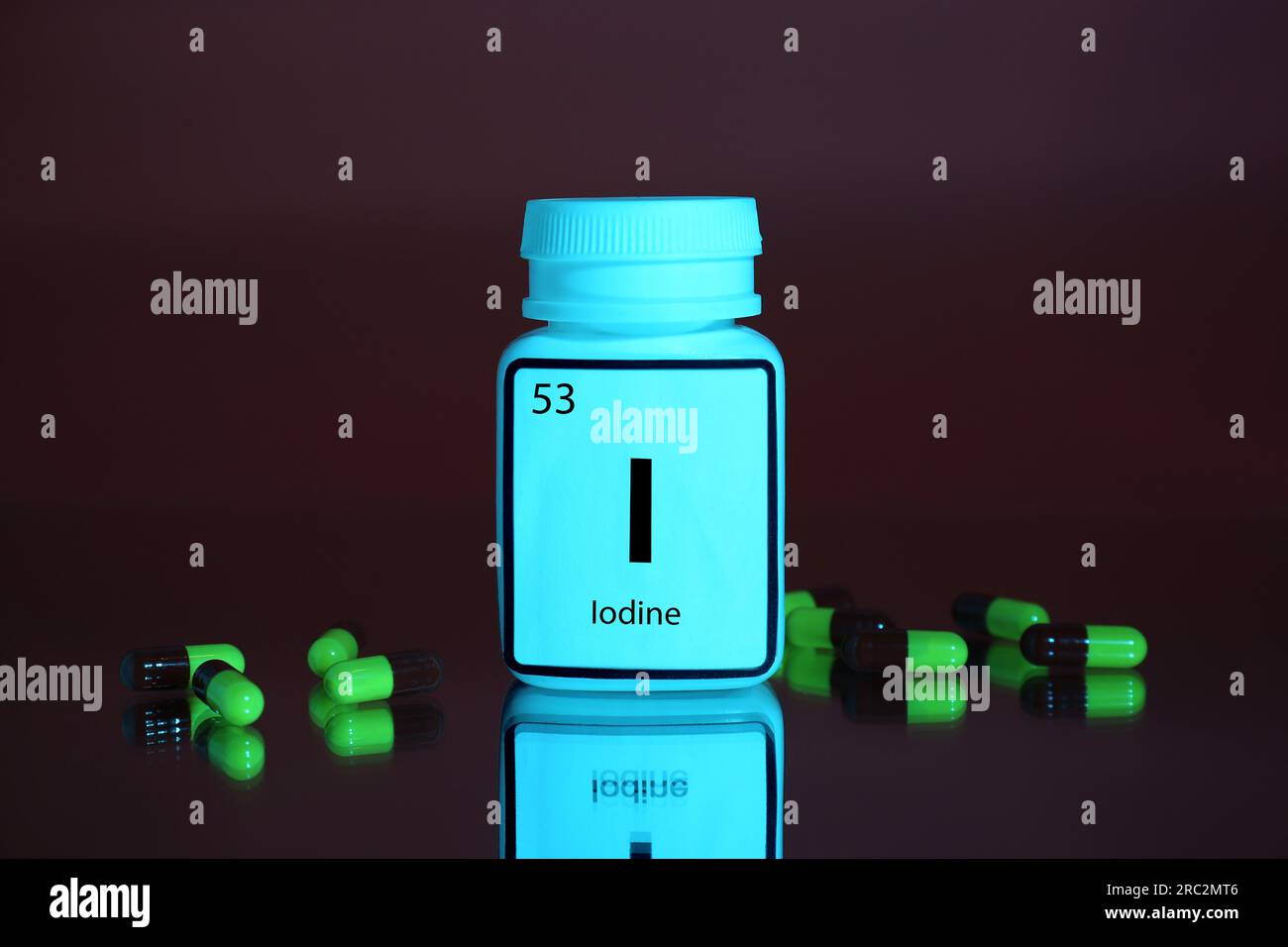 Bottle of medical iodine and pills on brown background, color tone ...