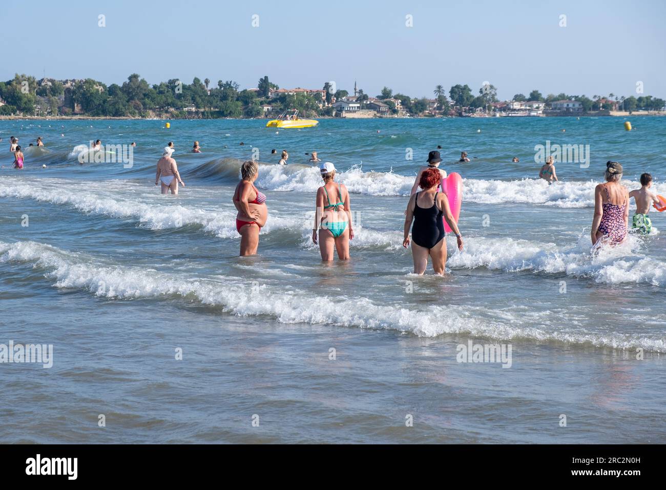 People Crowd Relaxing On Beach. Swimming people in sea Stock Photo - Alamy